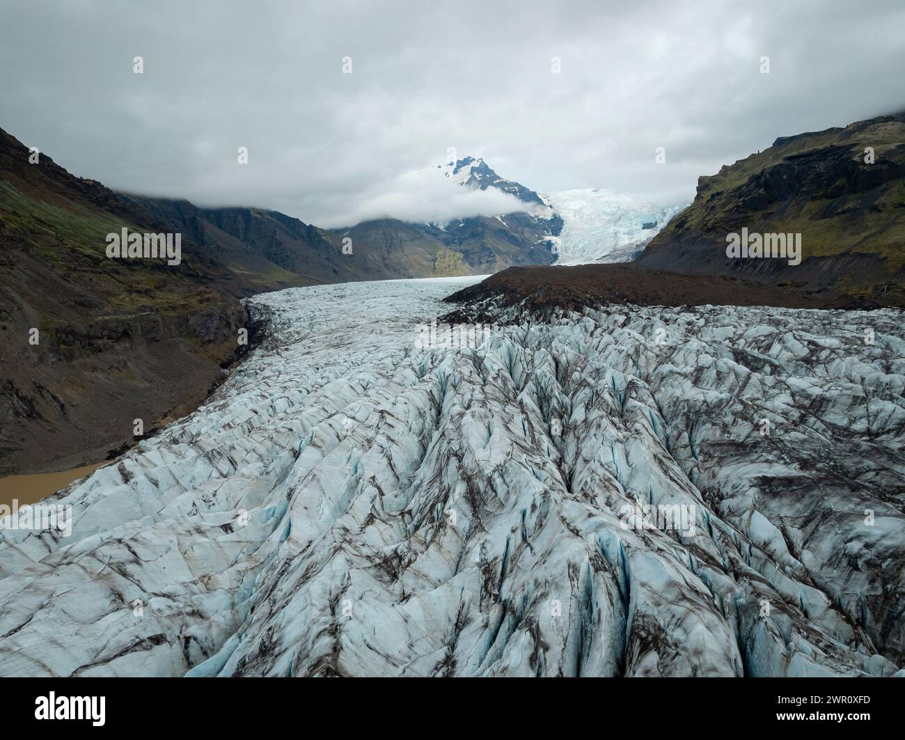 Dramatic Icelandic landscape of glacier tongue spurting off ice cap ...