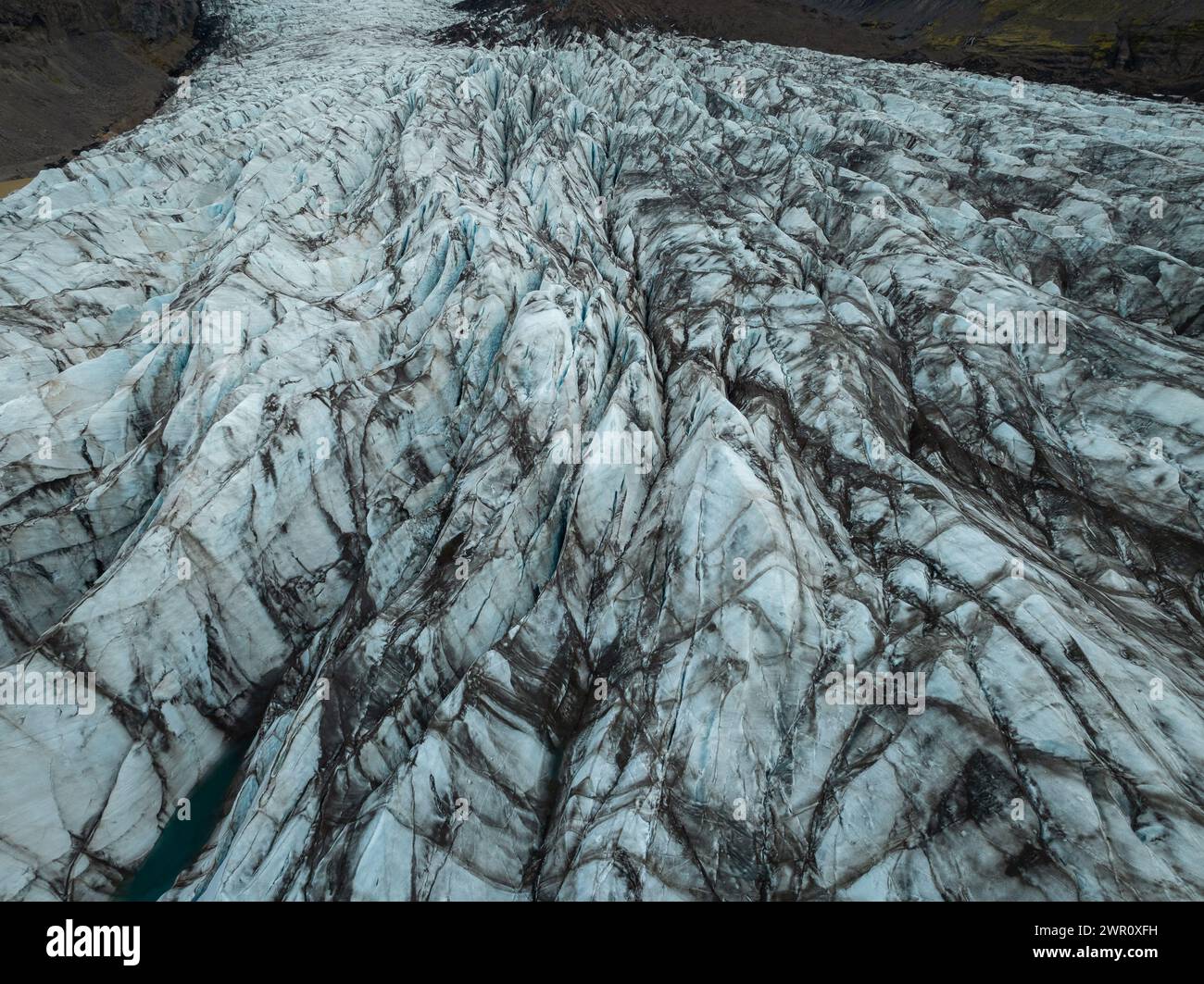 Ice terraces of glacier tongue, rough surface with crack pattern dirty ...