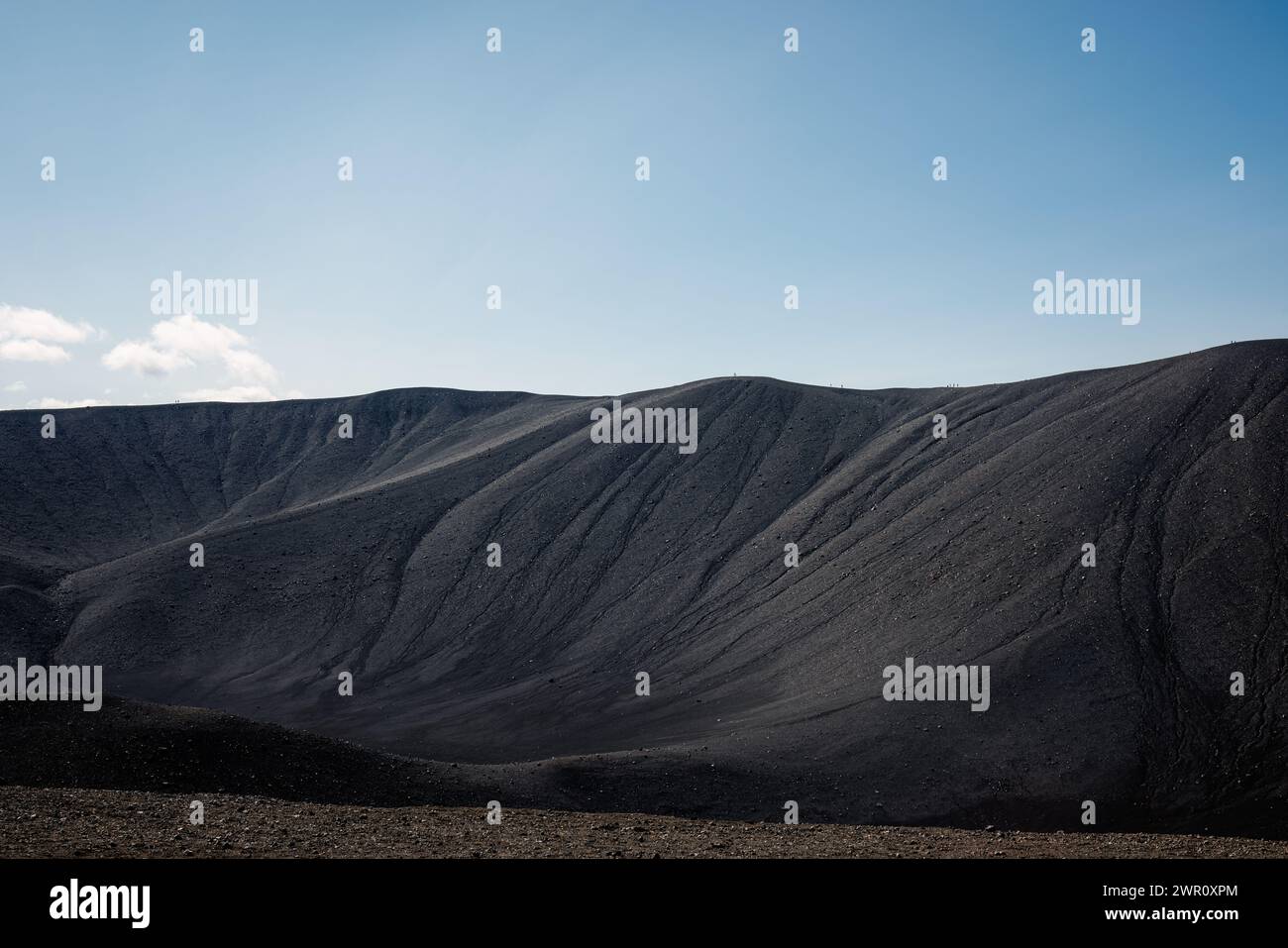 Black volcanic sand surface on the crater rim, close up aerial view ...