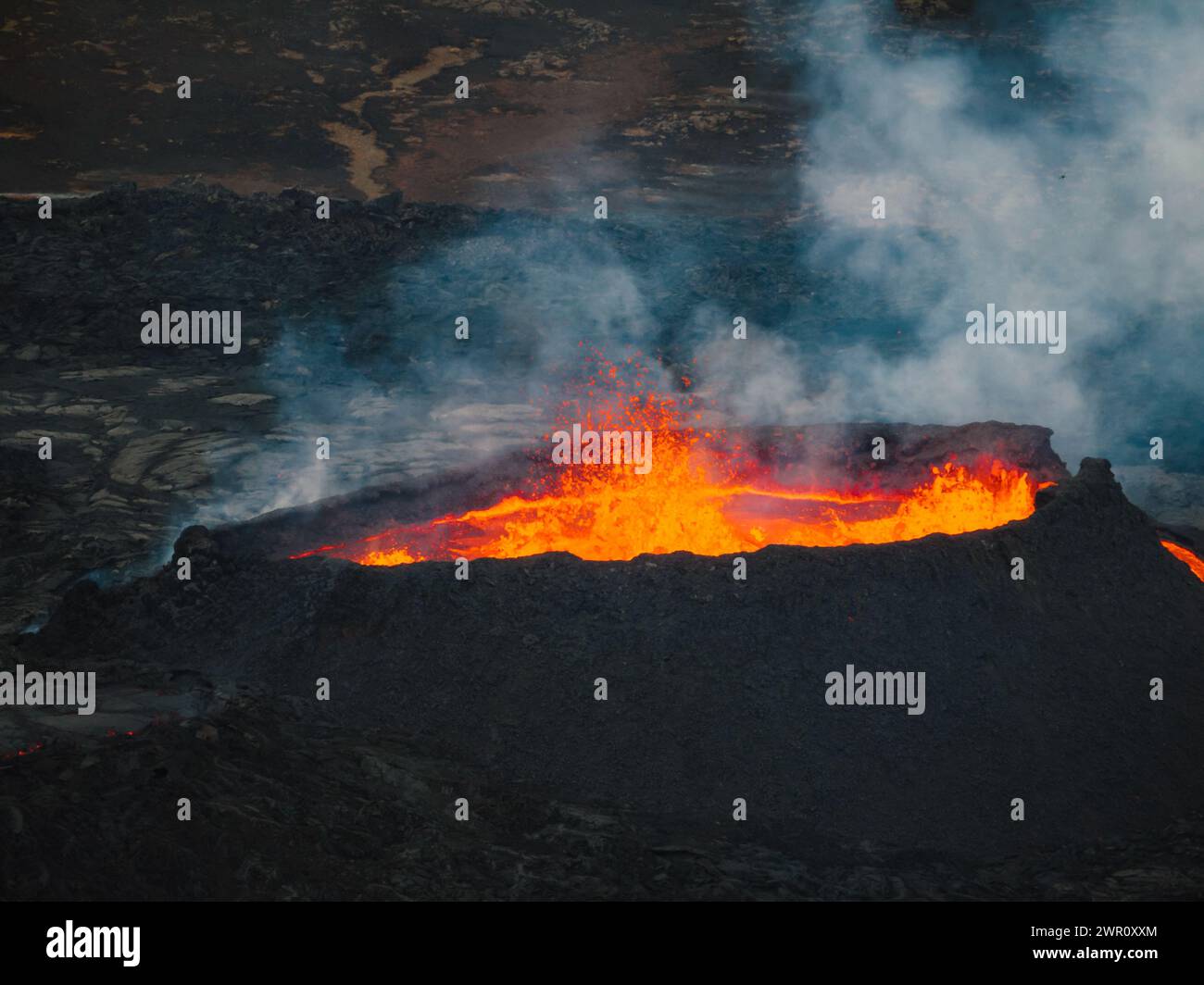 Unique view of the erupted volcano and surroundings, boiling red hot ...