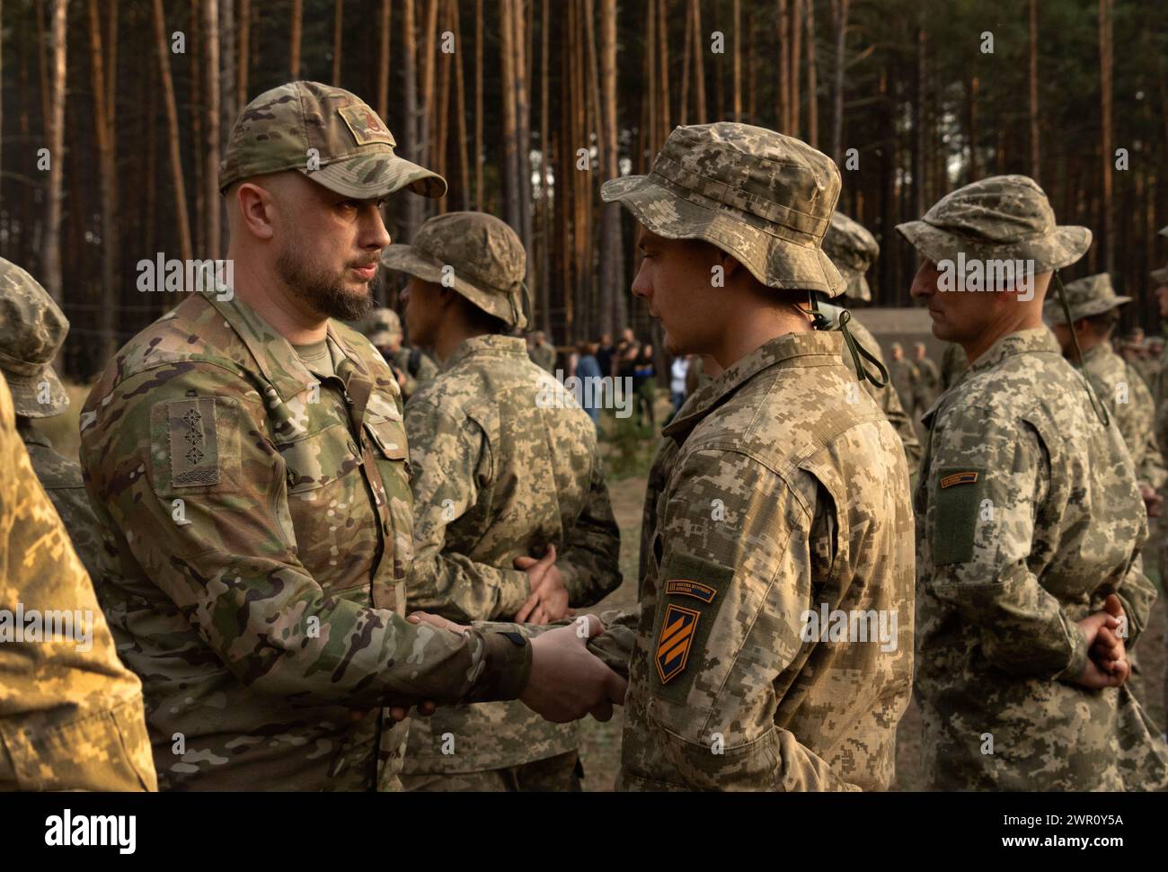 Commander of Ukraine's 3rd Assault Brigade Andriy Biletsky, left, shakes hands with newly ...