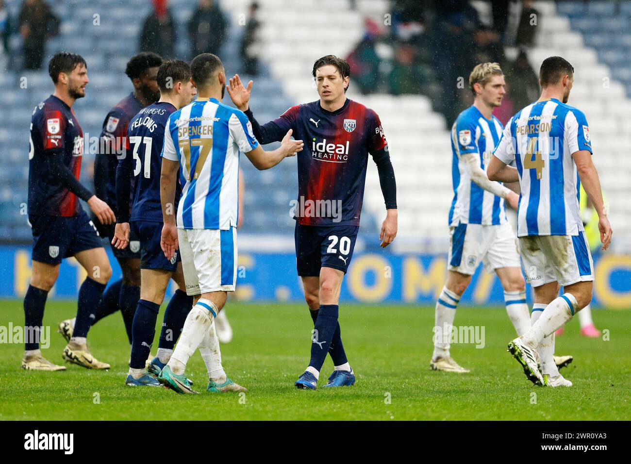 West Bromwich Albion's Adam Reach (centre) with Huddersfield Town's ...