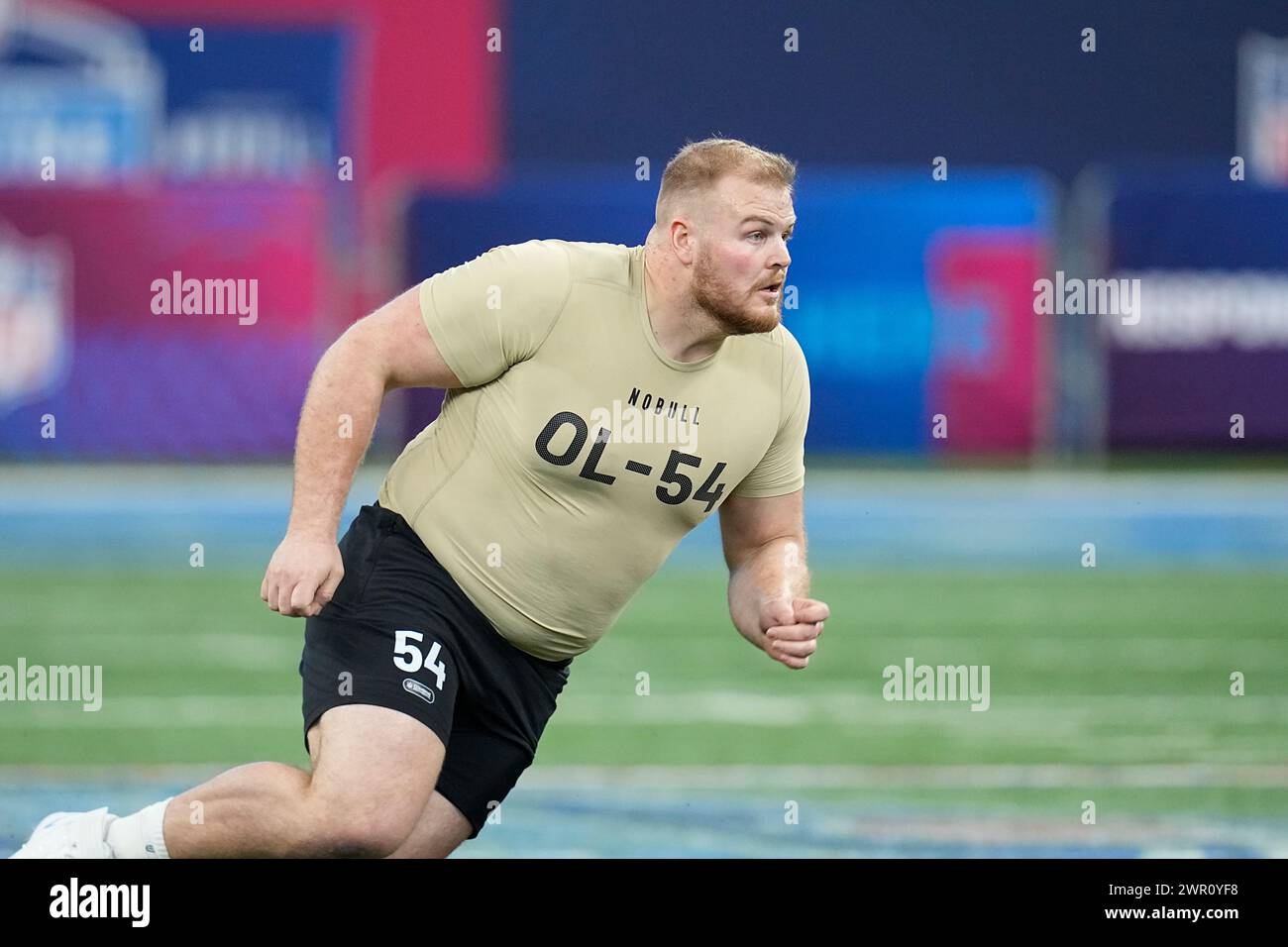 Michigan offensive lineman Drake Nugent runs a drill at the NFL ...
