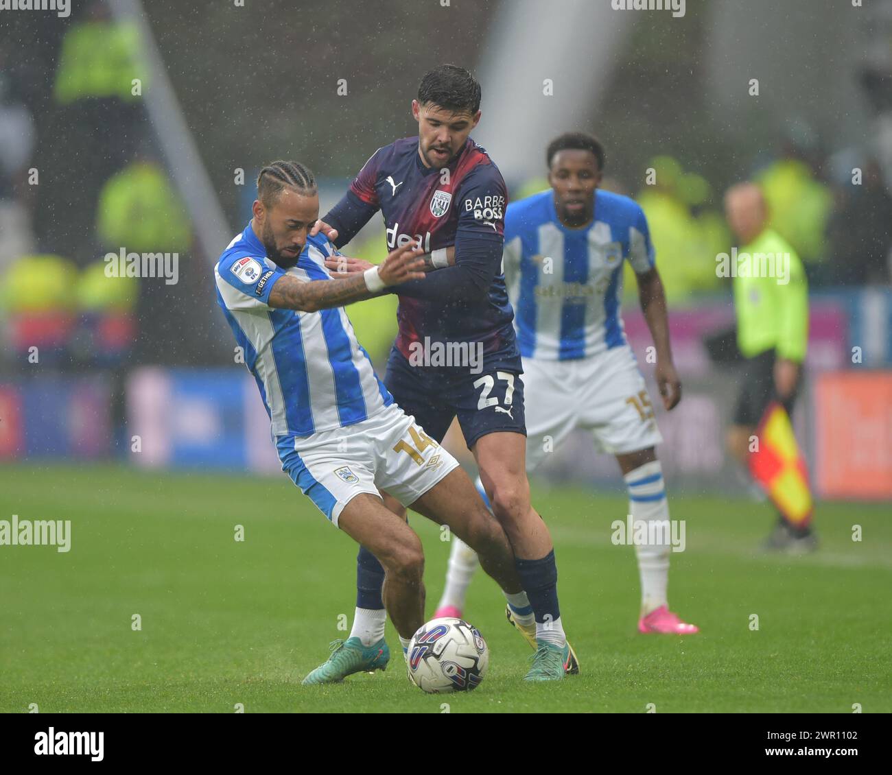Sorba Thomas of Huddersfield Town wins the ball from Alex Mowatt of ...