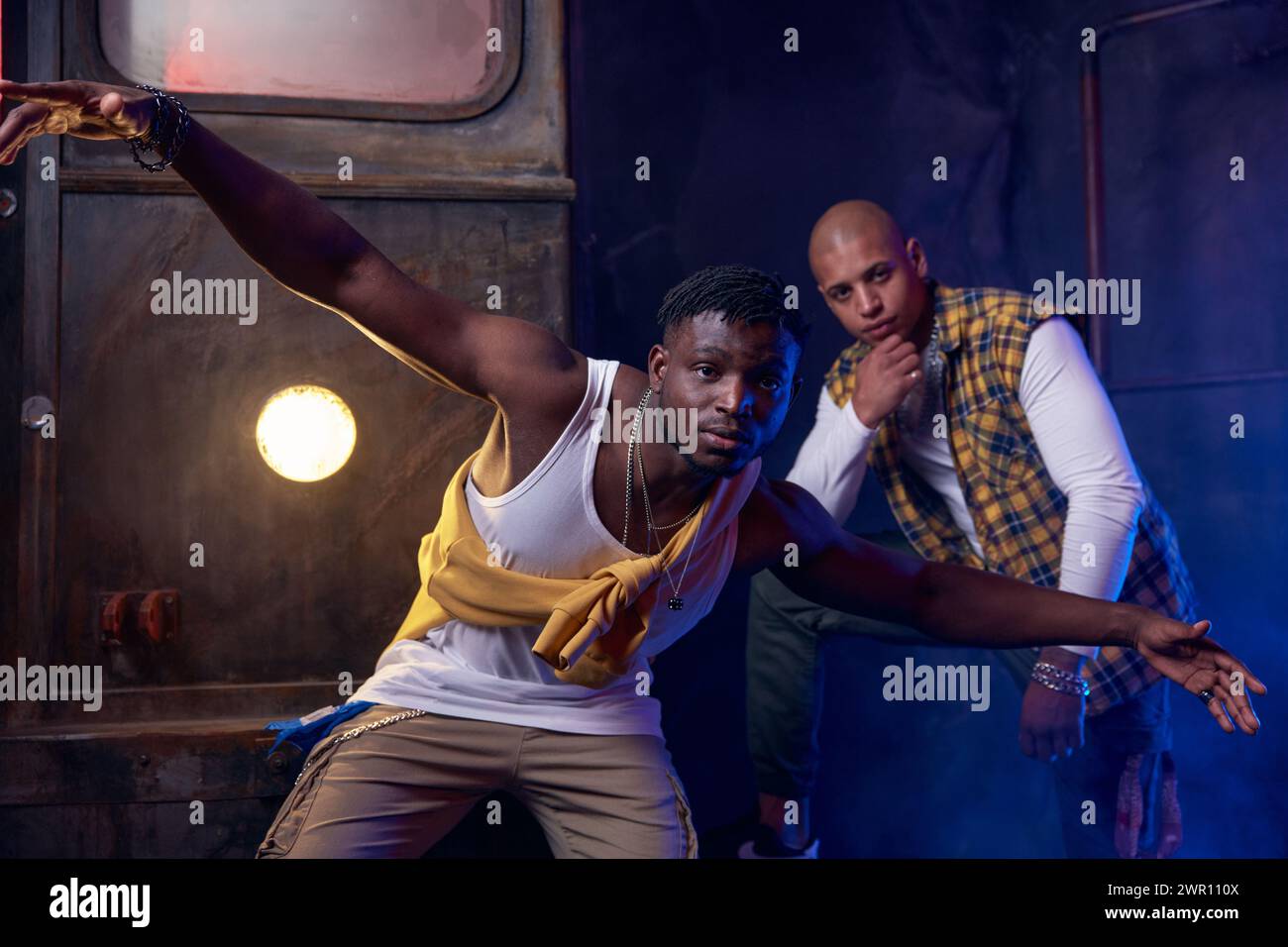 Two modern hip-hop dancers in garage performing urban freestyle dance ...