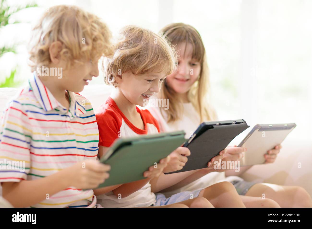 Kids with mobile phone. Child with tablet computer watching movie or ...