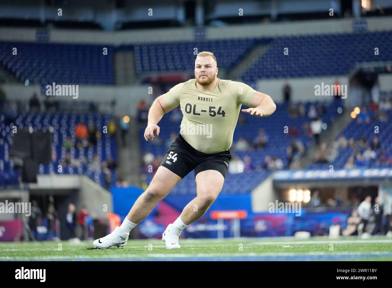 Michigan offensive lineman Drake Nugent runs a drill at the NFL ...
