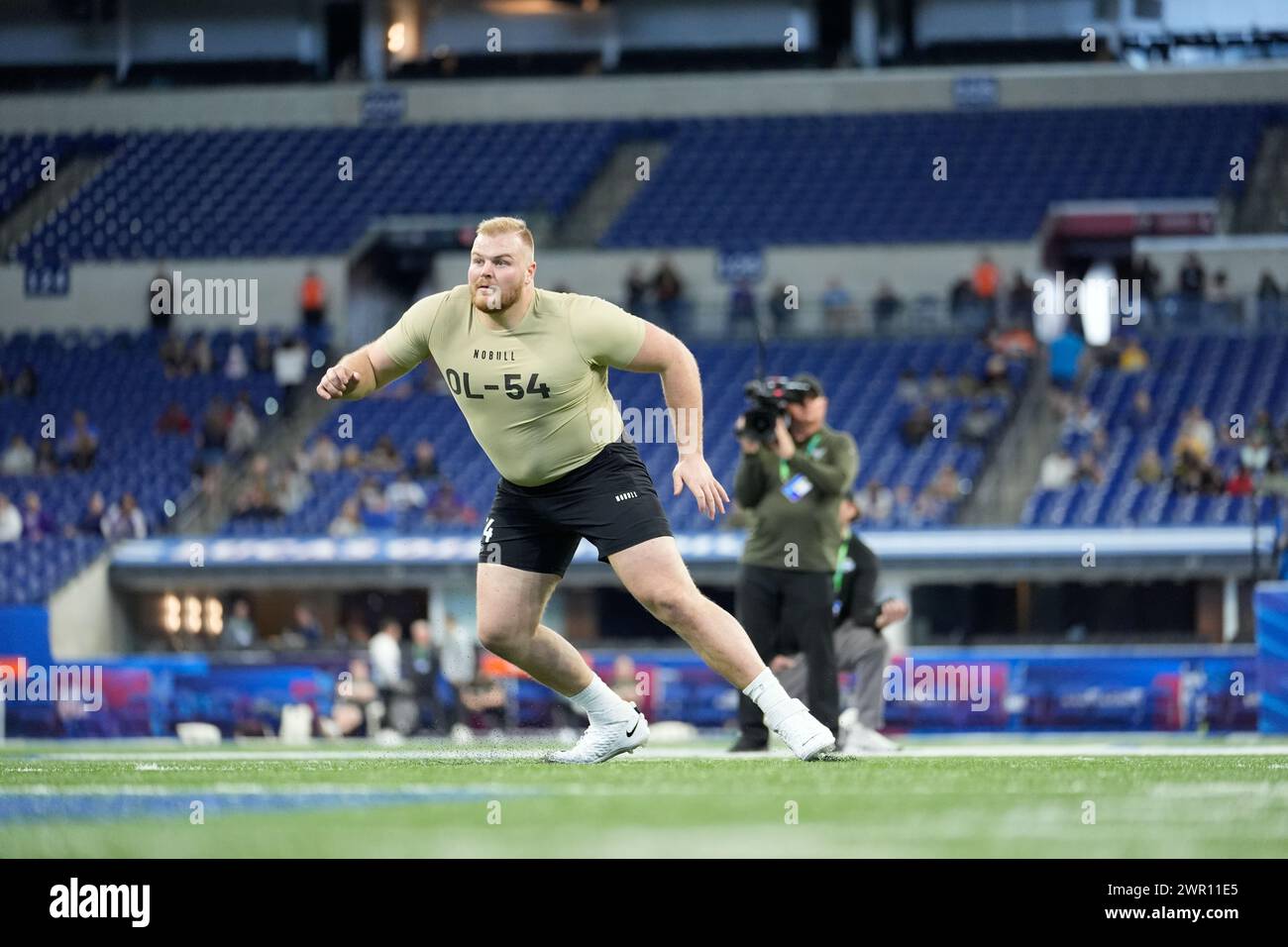 Michigan offensive lineman Drake Nugent runs a drill at the NFL ...