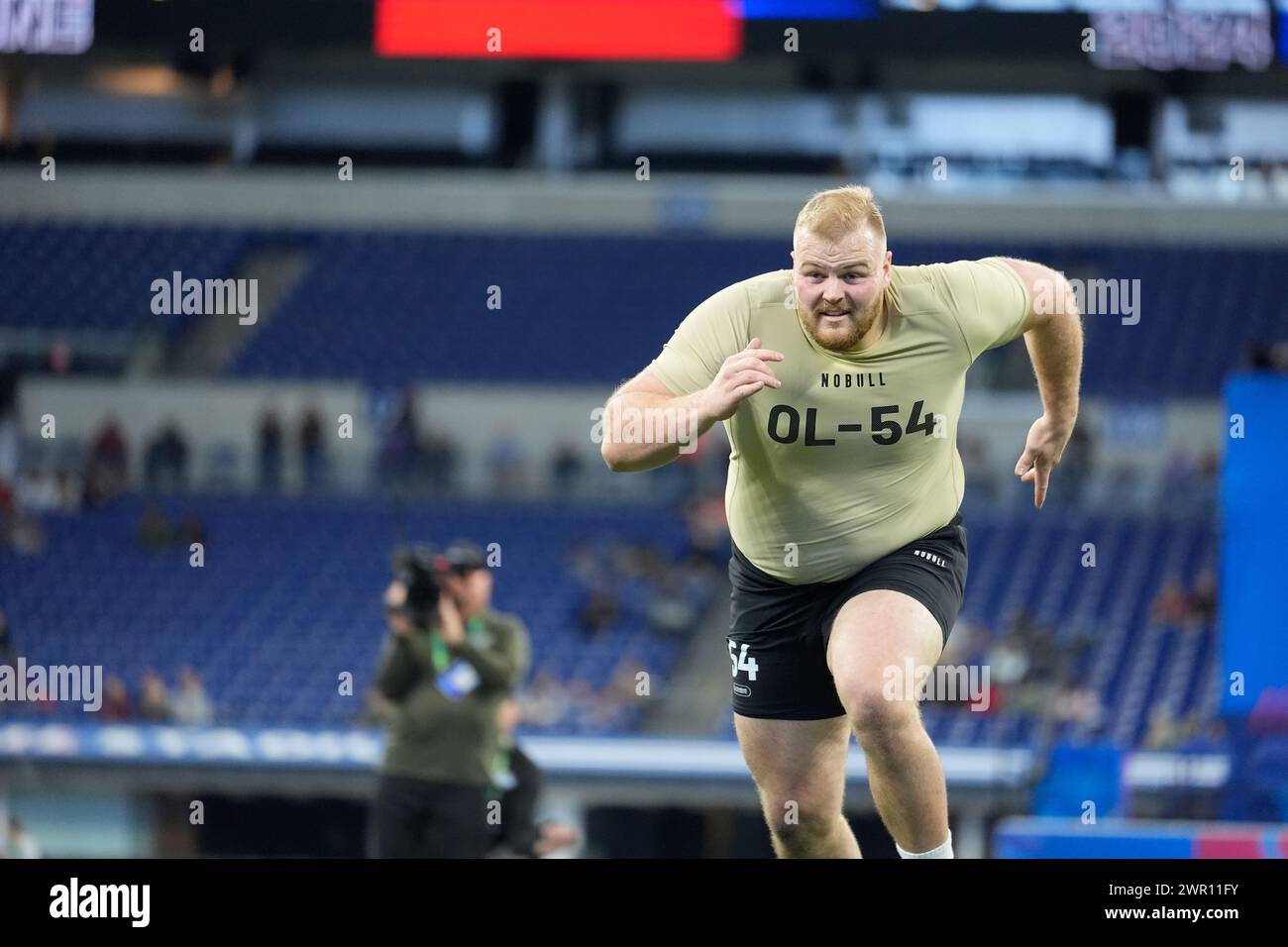 Michigan offensive lineman Drake Nugent runs a drill at the NFL ...