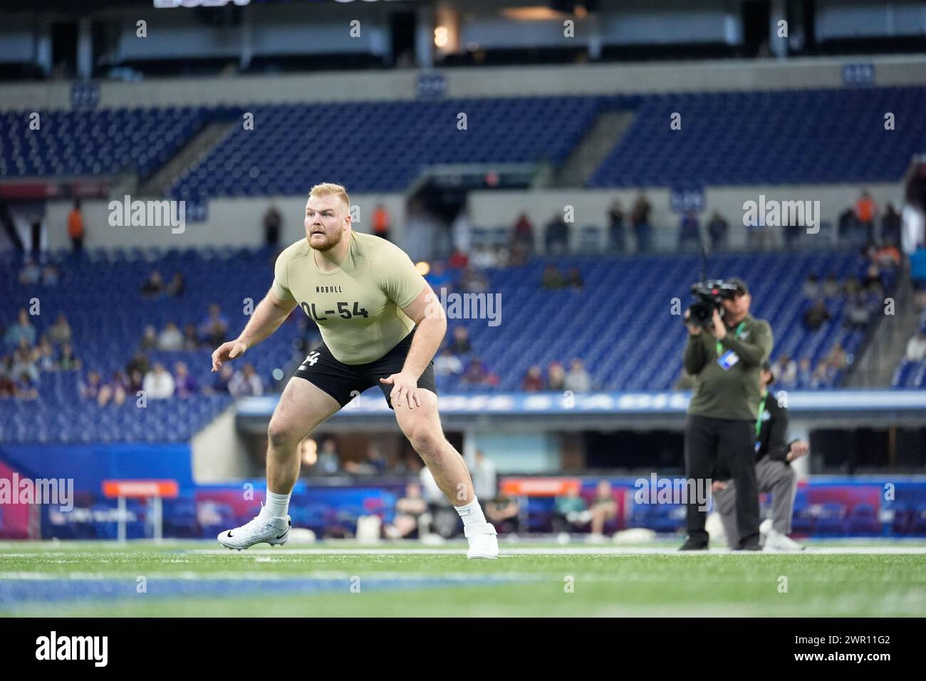 Michigan offensive lineman Drake Nugent runs a drill at the NFL ...