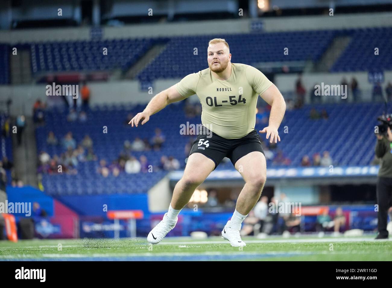 Michigan offensive lineman Drake Nugent runs a drill at the NFL ...