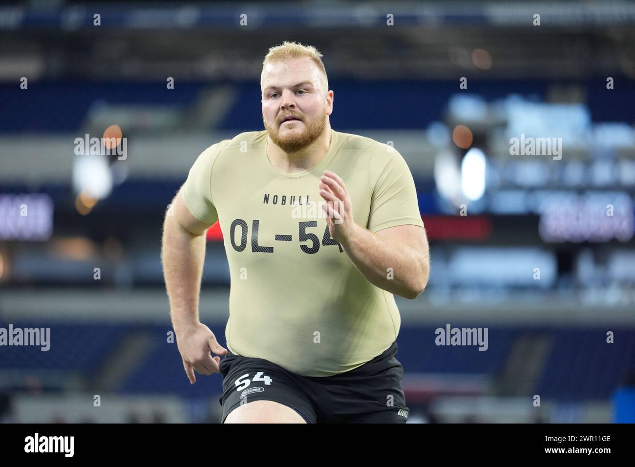 Michigan offensive lineman Drake Nugent runs a drill at the NFL ...