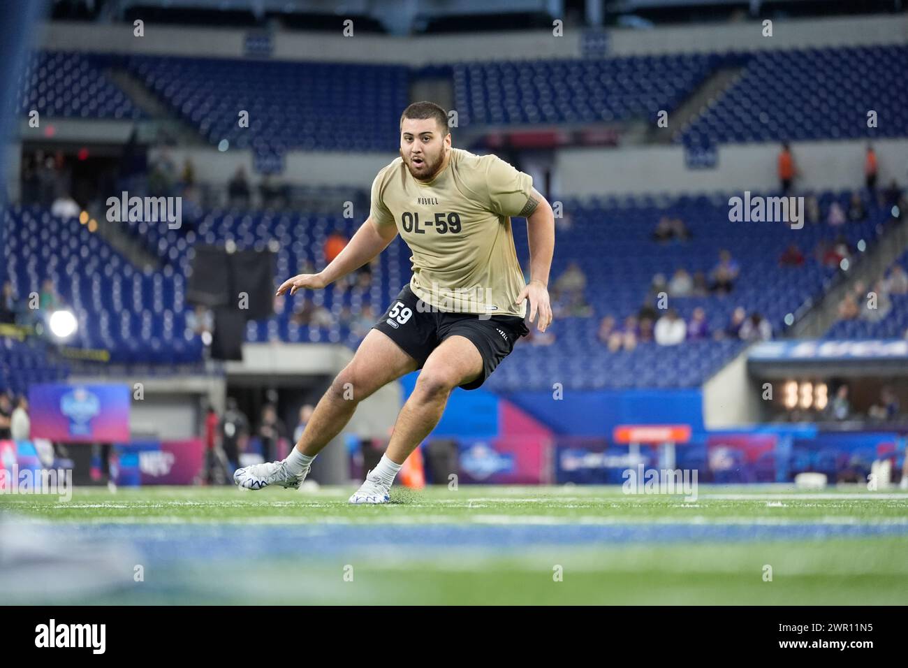 Kansas offensive lineman Dominick Puni runs a drill at the NFL football ...
