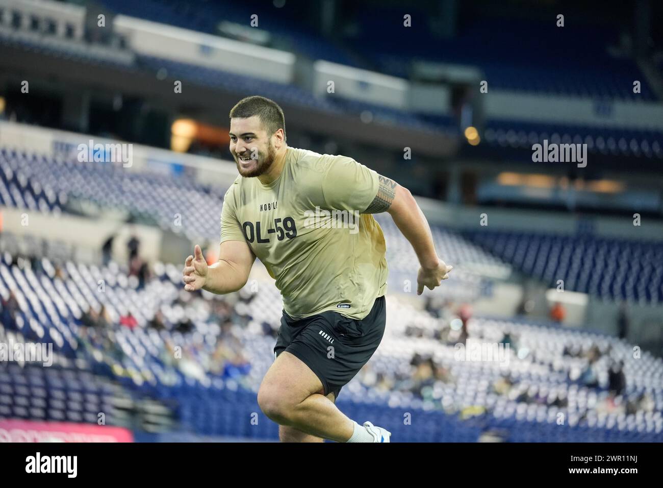 Kansas offensive lineman Dominick Puni runs a drill at the NFL football ...