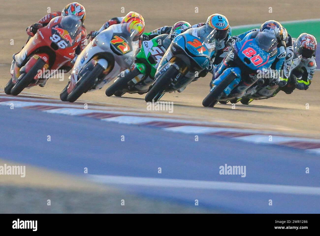 Pack of riders compete during the Moto3 race of the Qatar Motorcycle ...