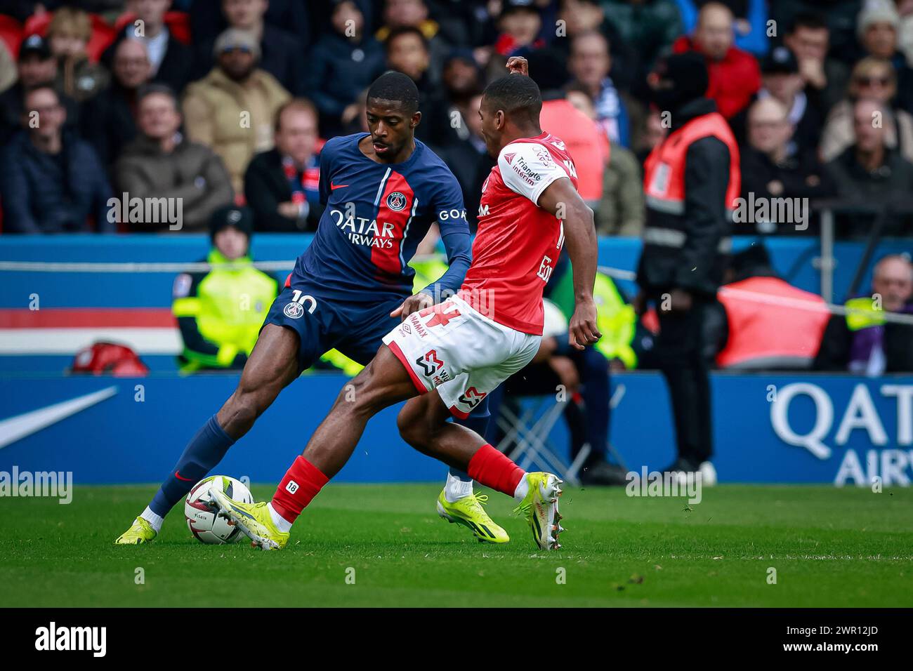 PSG's Ousmane Dembele, left, and Reims' Sergio Akieme fight for the ...