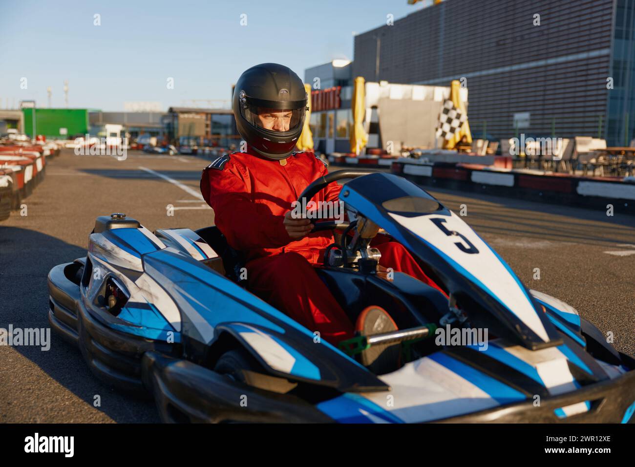 Go-cart racer moving fast on open air motor racing track Stock Photo ...