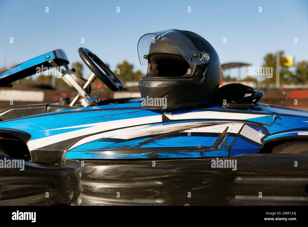 Closeup helmet on go-cart car at automotive speedway stadium Stock ...