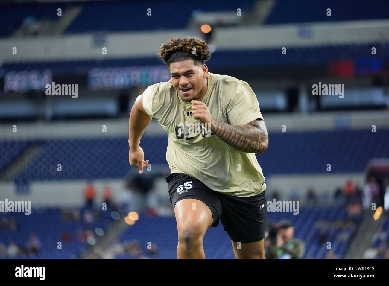 Brigham Young offensive lineman Kingsley Suamataia runs a drill at the NFL football scouting ...