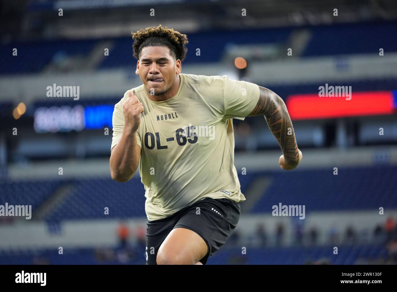Brigham Young offensive lineman Kingsley Suamataia runs a drill at the NFL football scouting ...