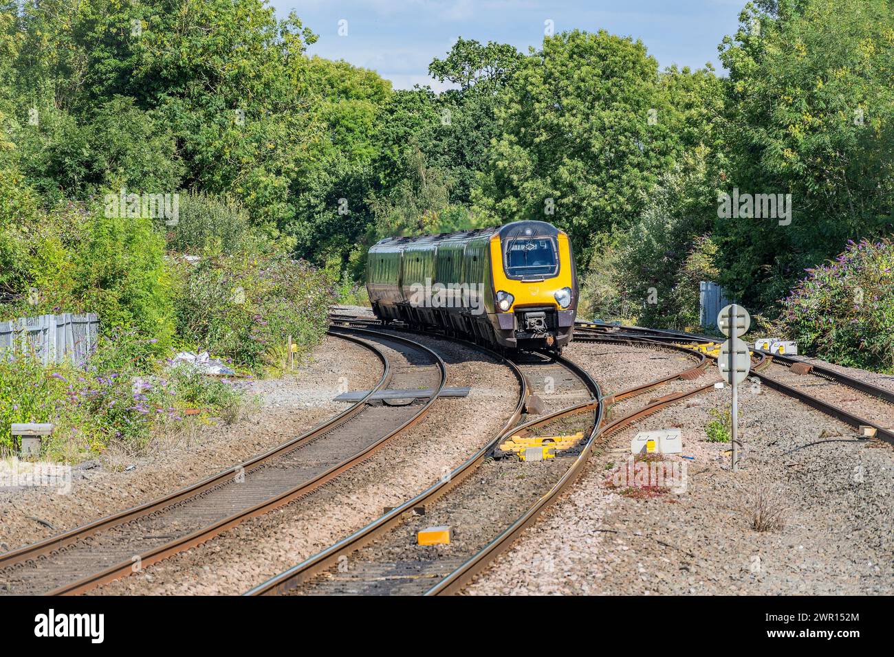 Express passenger train passing through commuter station west midlands ...