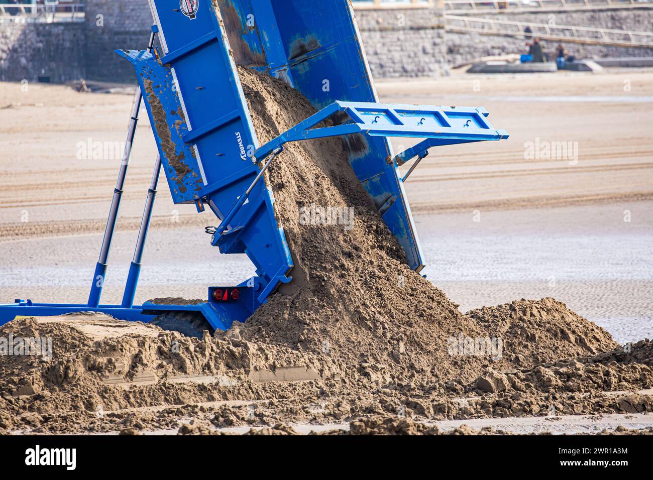 trailer tipping sand on Weston Super Mare Beach to combat the effect of ...