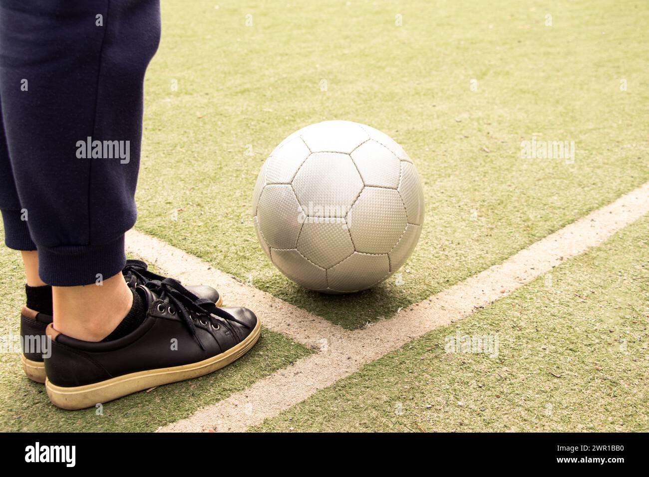 Women's legs on a football field and a gray soccer ball in Ukraine ...
