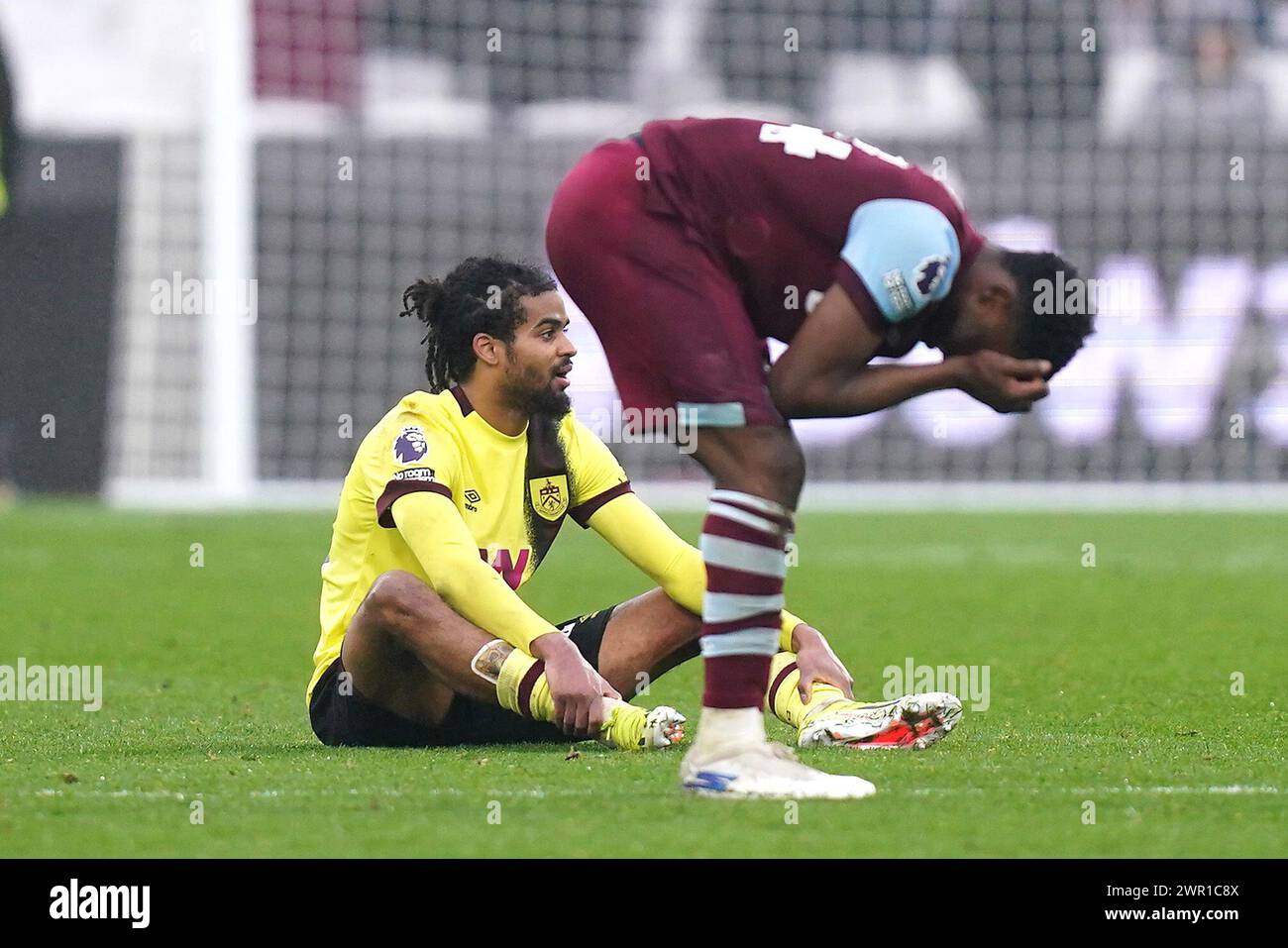 Burnley's Lorenz Assignon (left) and West Ham United's Mohammed Kudus ...