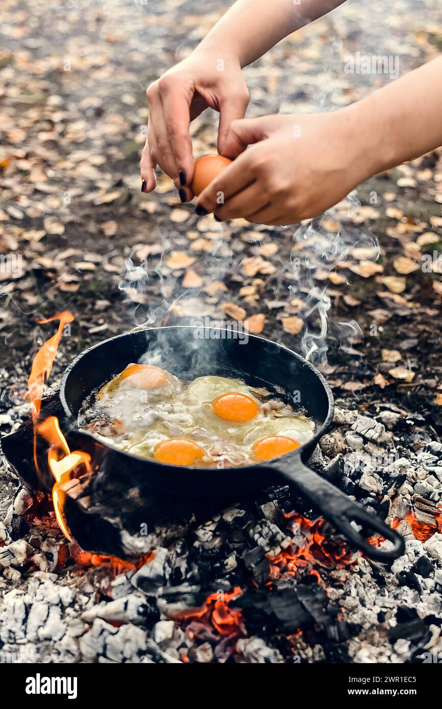 fried bacon in a pan over a campfire in the forest Stock Photo - Alamy