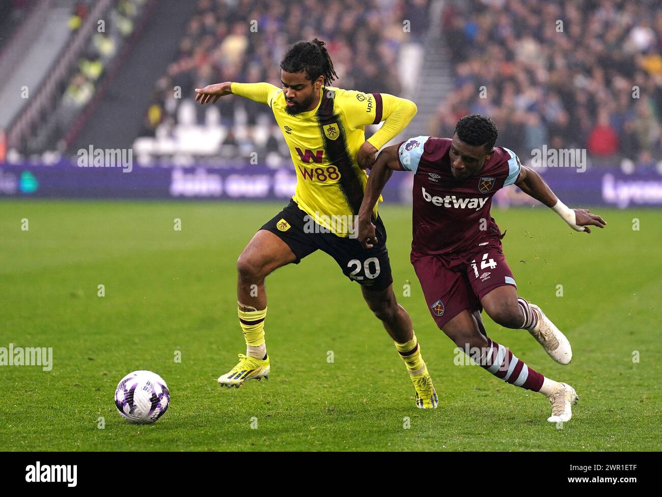 Burnley's Lorenz Assignon (left) and West Ham United's Mohammed Kudus ...