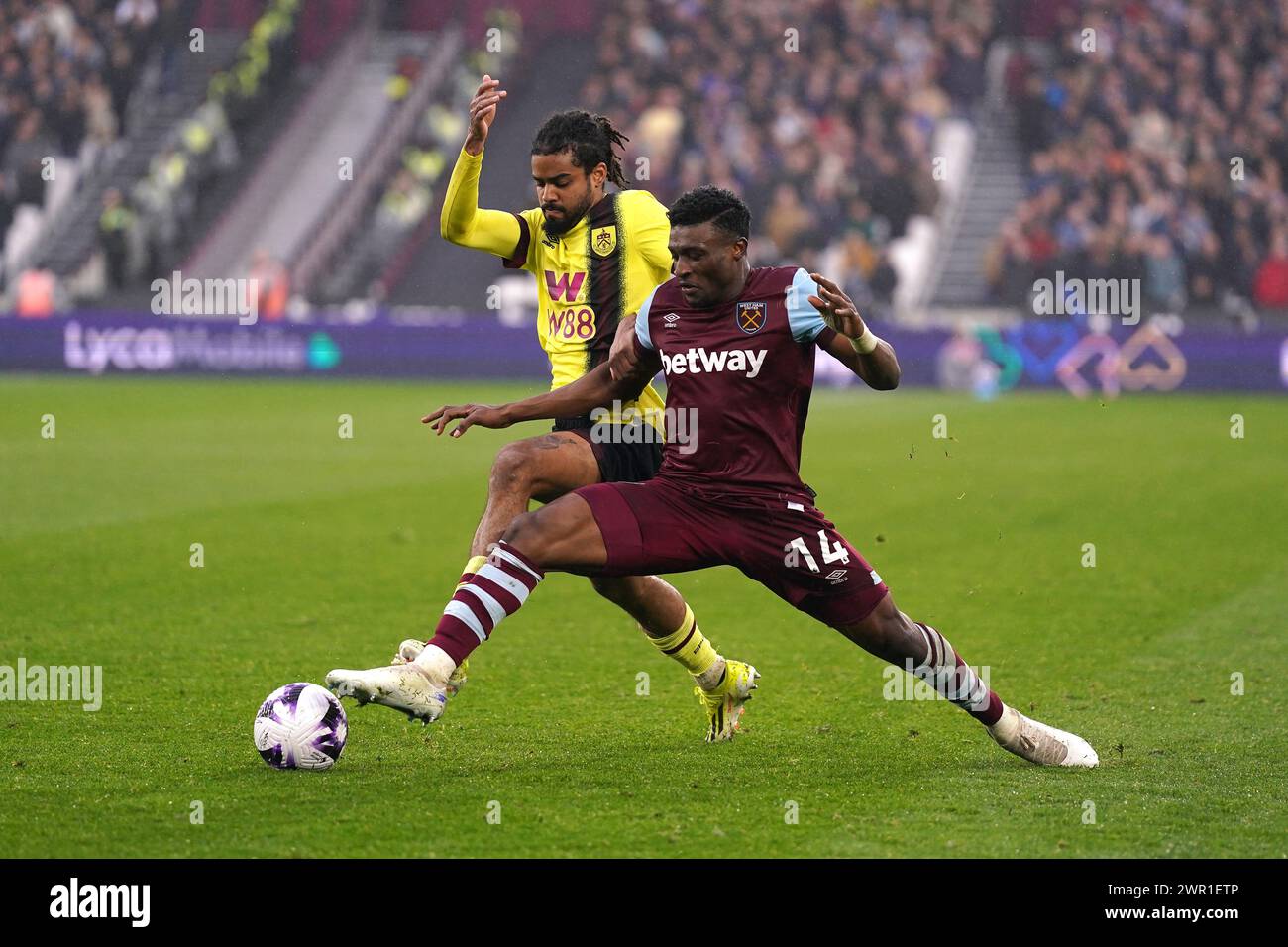 Burnley's Lorenz Assignon (left) and West Ham United's Mohammed Kudus ...