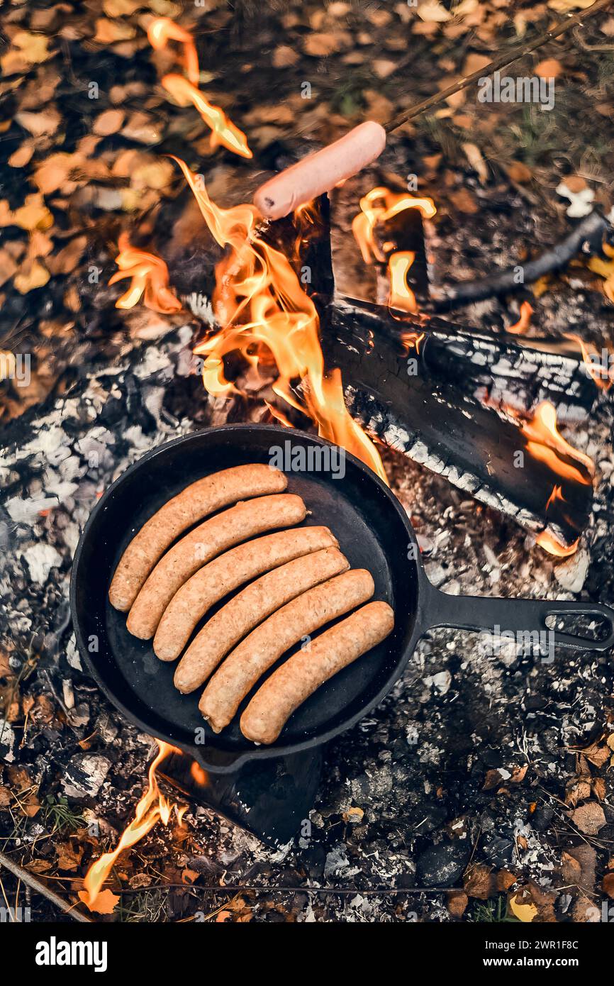 fried bacon in a pan over a campfire in the forest Stock Photo - Alamy
