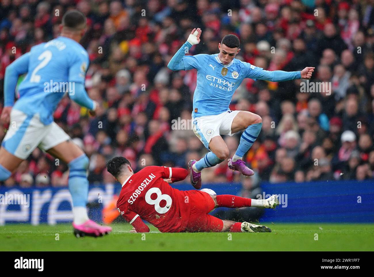 Liverpool's Dominik Szoboszlai (left) challenges Manchester City's Phil ...