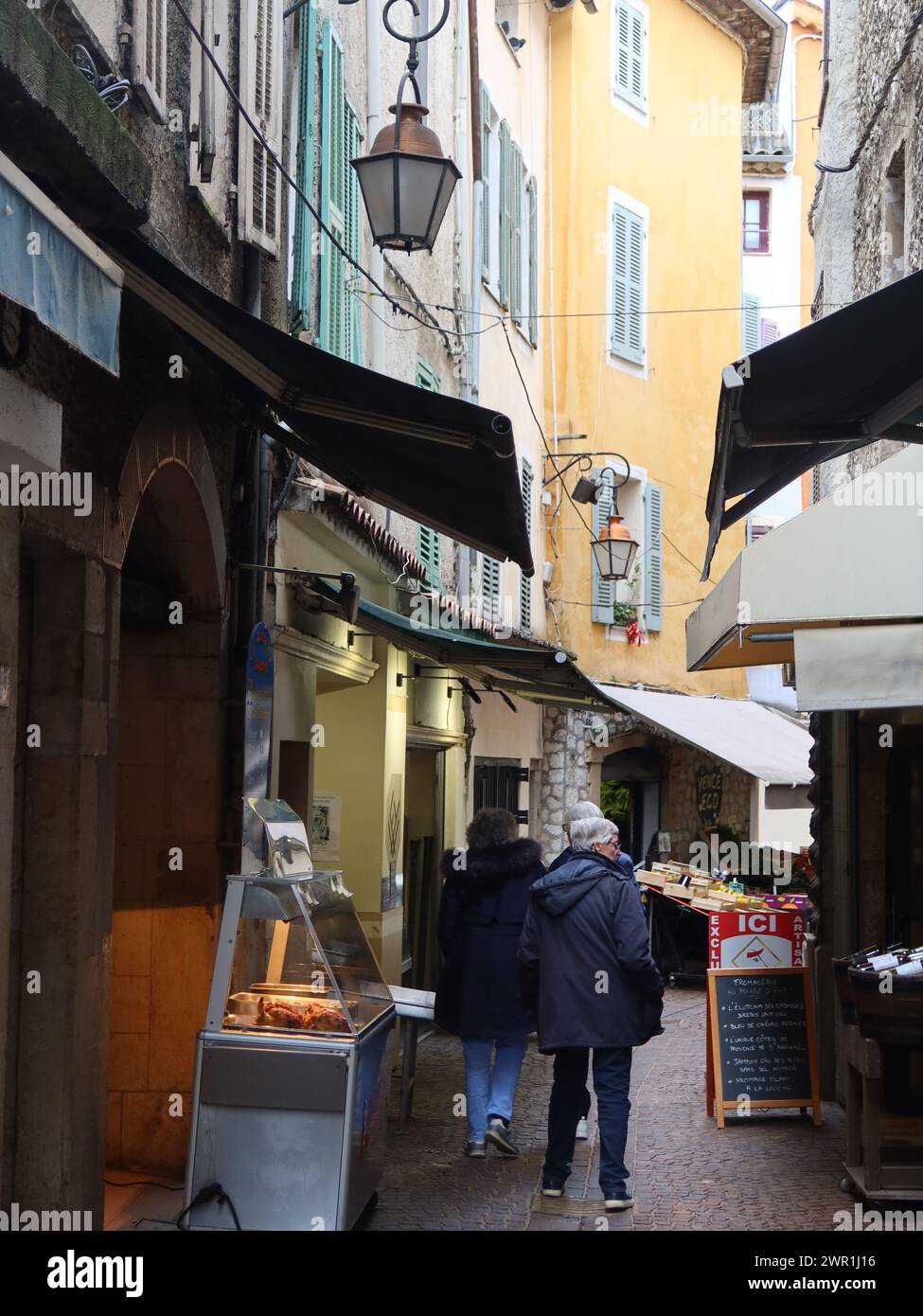 Narrow, cobbled streets of the medieval hilltop town of Vence are full ...