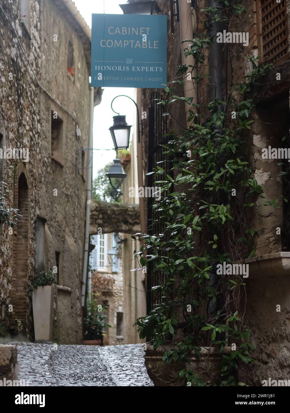 Atmospheric view of a cobbled street with tall buildings and old ...