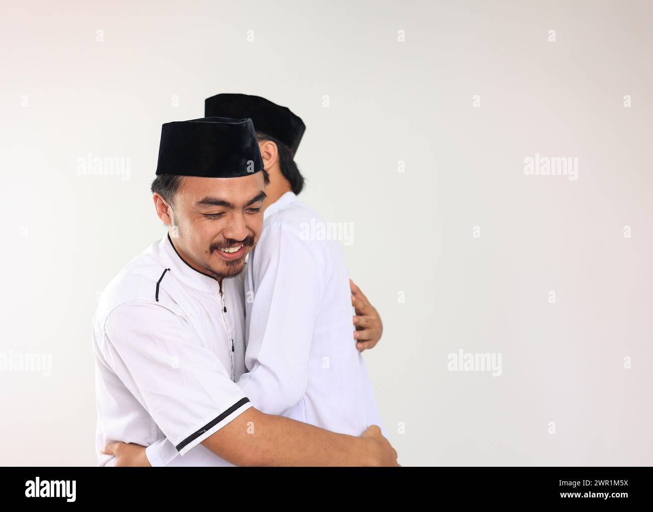 Two Young Indonesian Muslim Male Wearing Baju Koko and Black Kopyah Hug ...