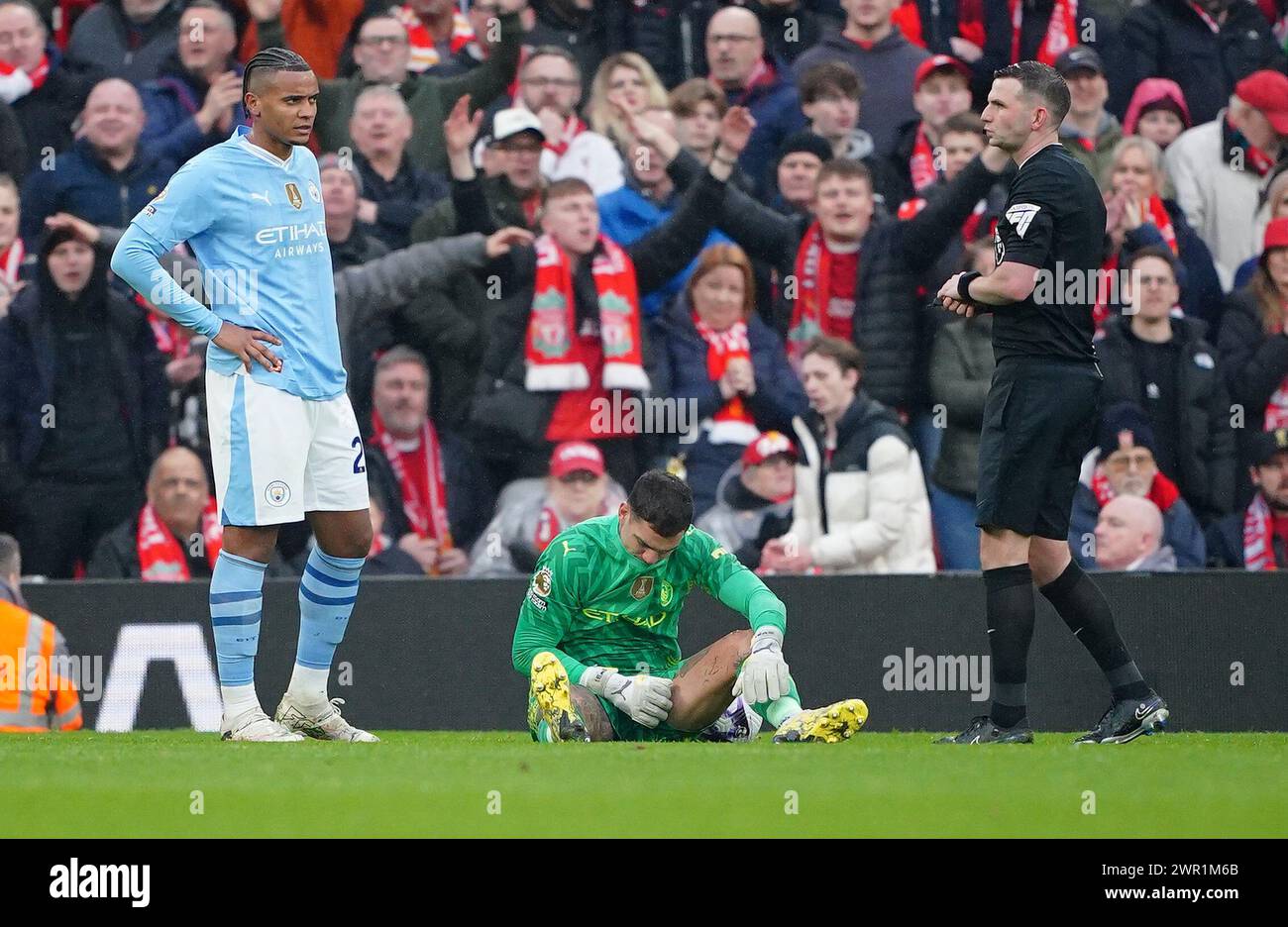 Manchester City goalkeeper Ederson sits injured during the Premier ...