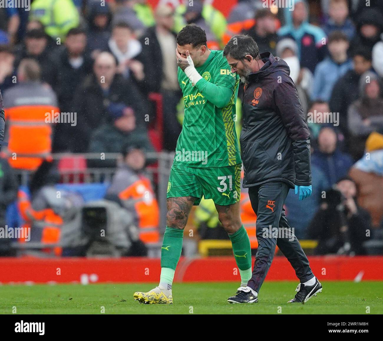 Manchester City goalkeeper Ederson leaves the game with an injury ...