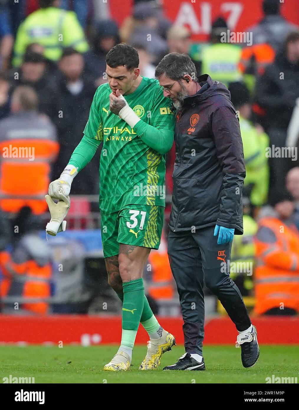 Manchester City goalkeeper Ederson leaves the game with an injury ...
