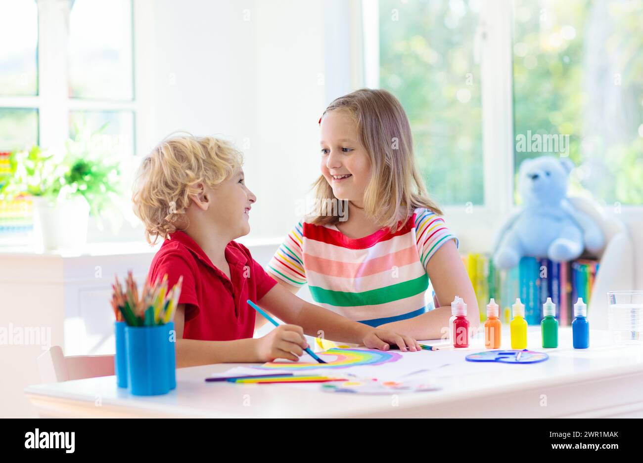 Kids paint. Child painting in white sunny study room. Little boy and ...