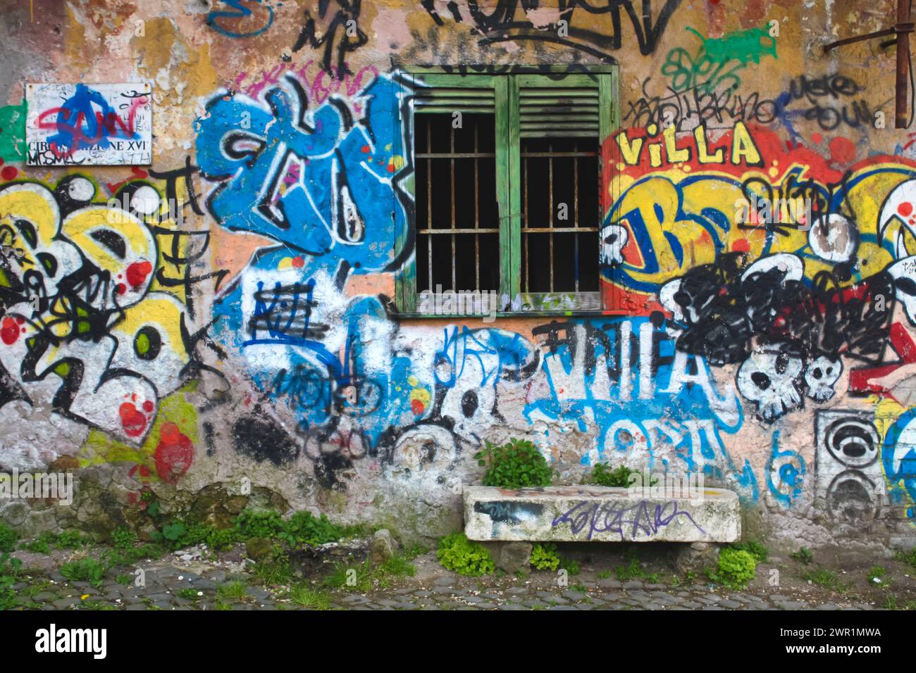 abstract mural of chaotic graffiti on a deteriorated building, with ...