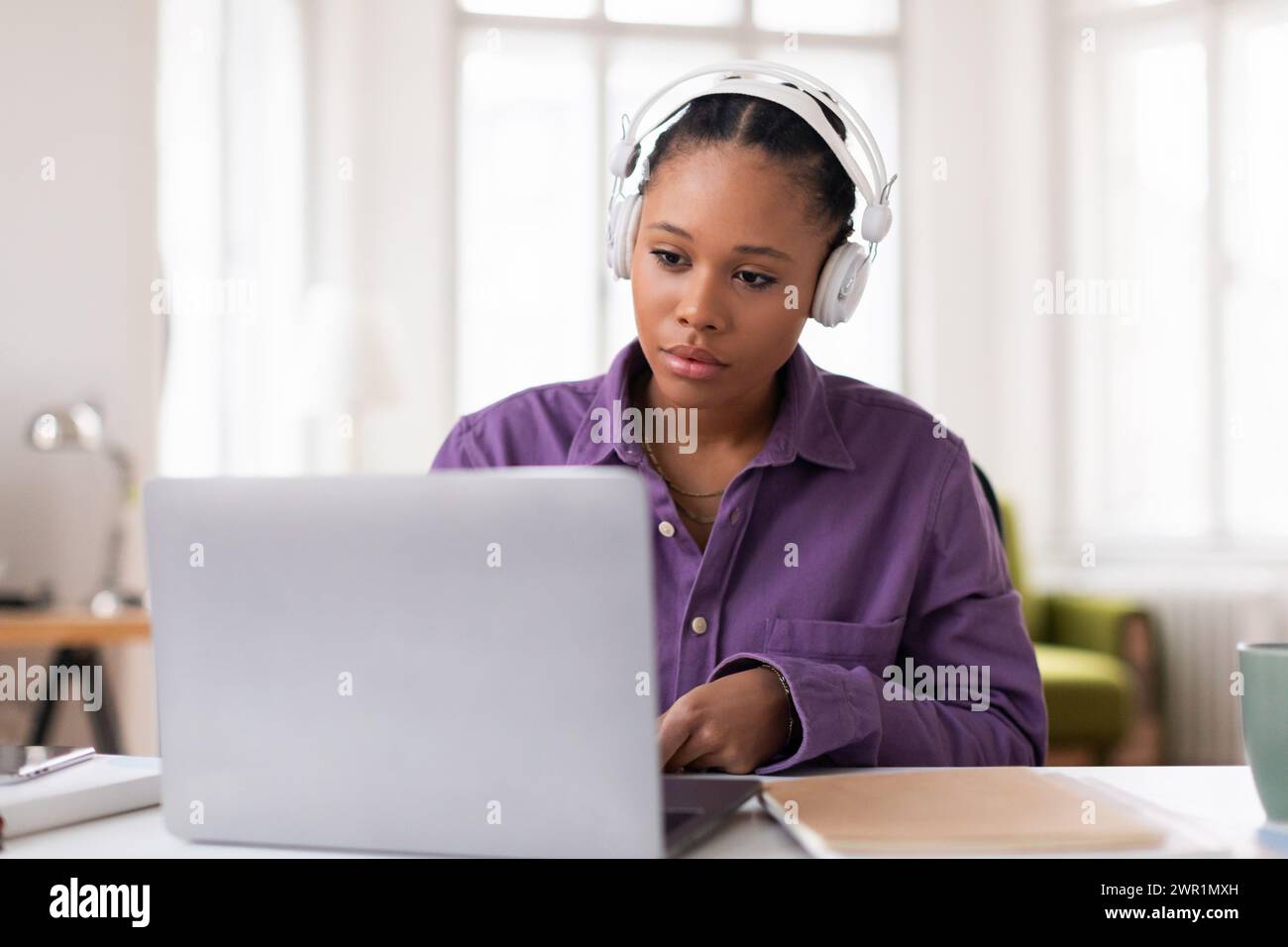 Concentrated young female student engaged hi-res stock photography and ...