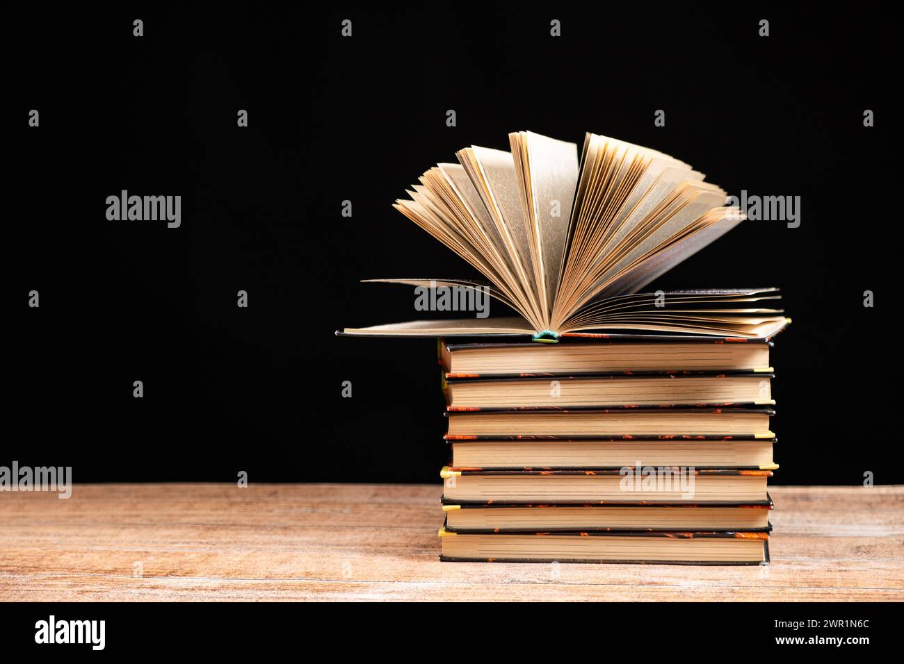 Stack of books on black background, open book, space for text Stock ...