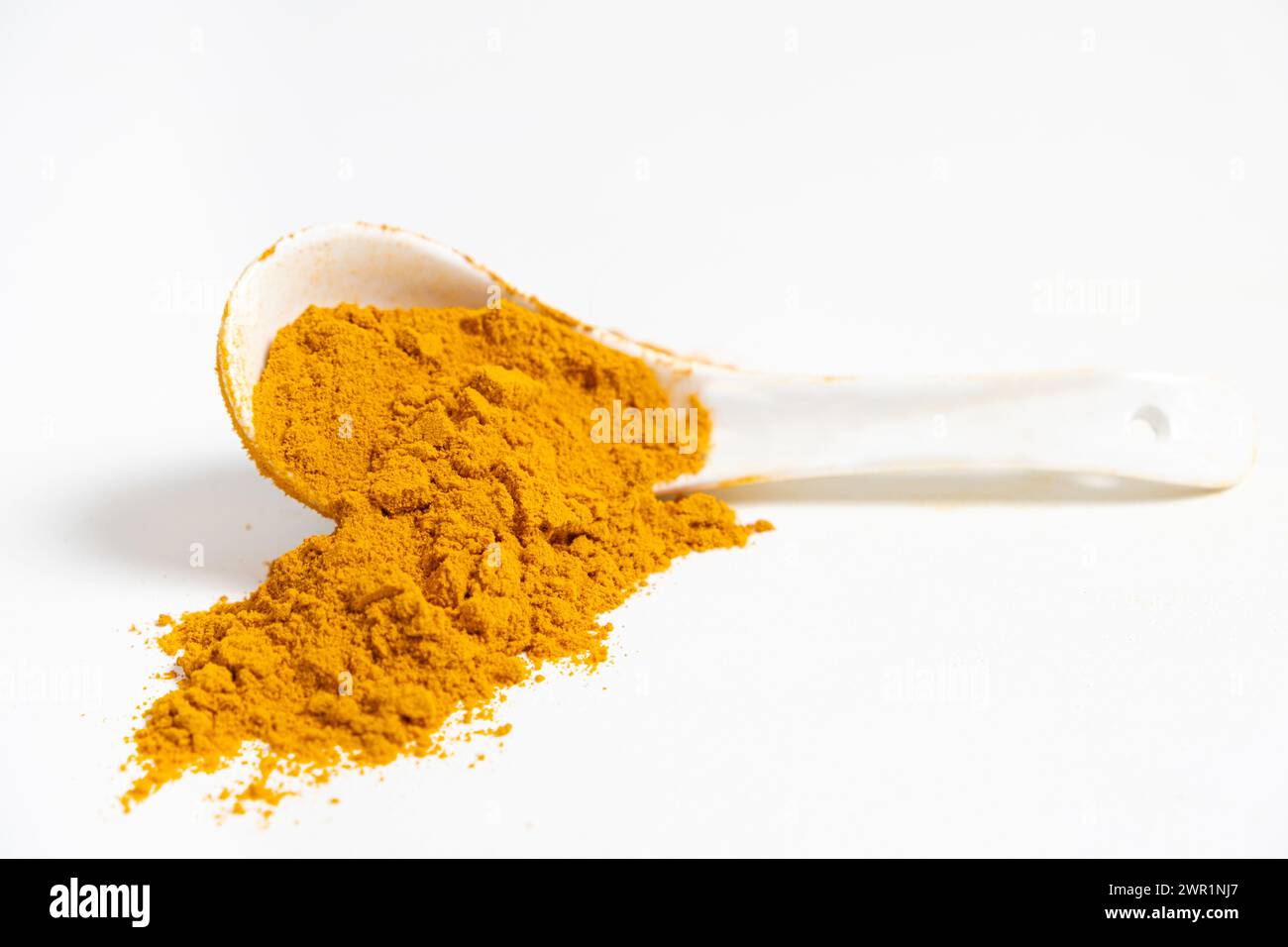 Scattered turmeric powder on white background, turmeric pattern and ...