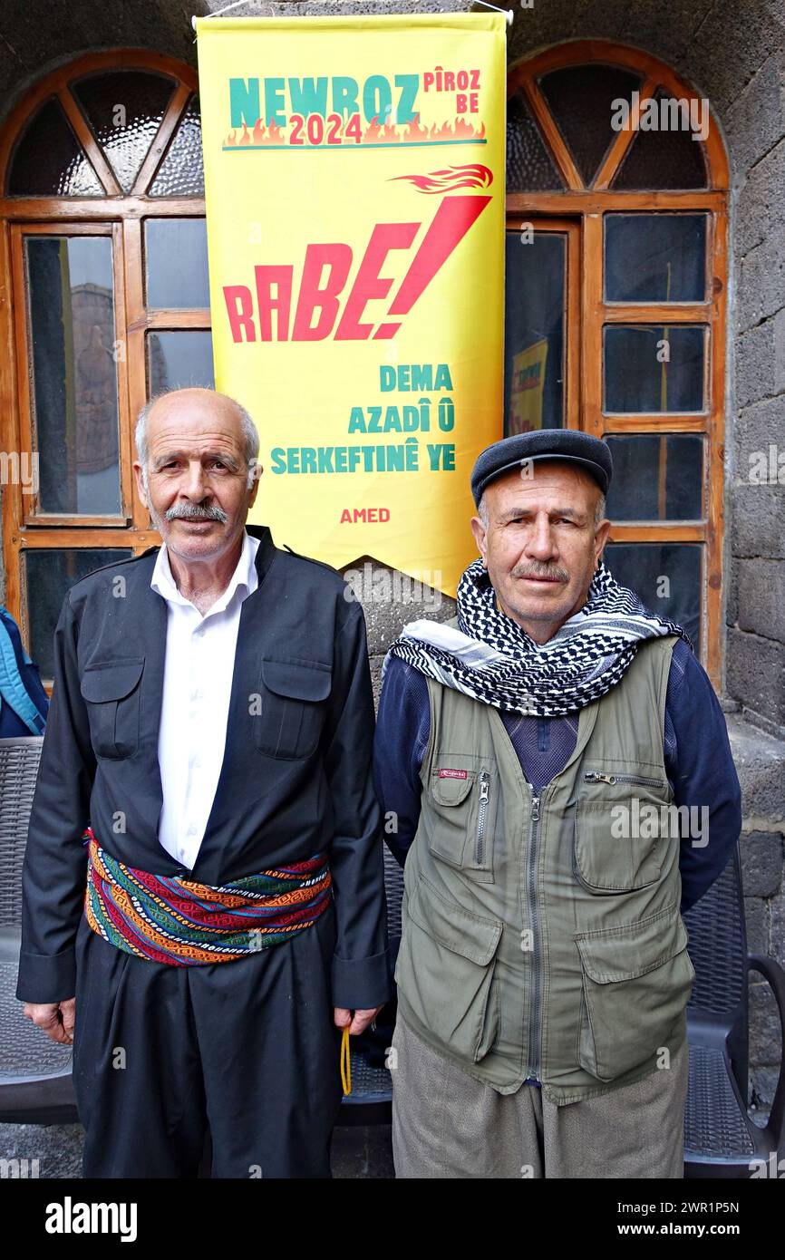 Two Kurds in traditional clothes are seen in front of the Newroz 2024 ...