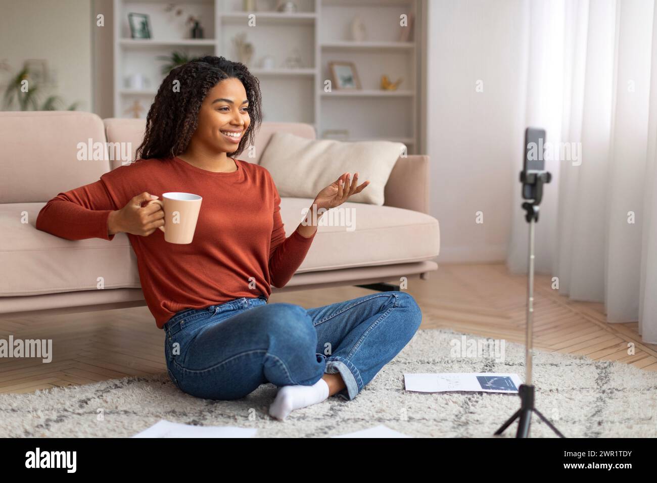 Happy young black woman recording a vlog on her smartphone Stock Photo ...