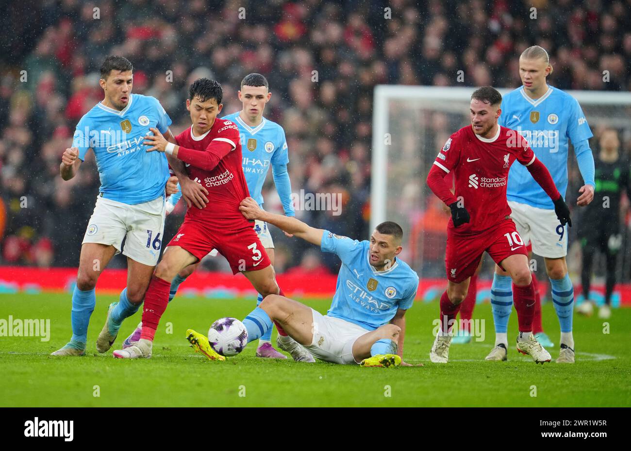 Manchester City's Rodrigo, left, and Mateo Kovacic, down, try to stop ...