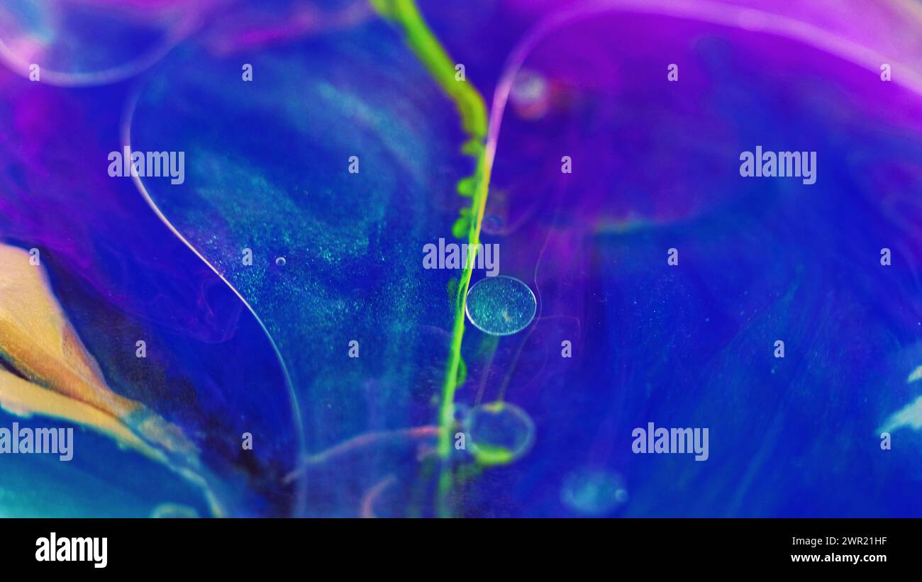 Oil blob glitter fluid ink water mix neon mist Stock Photo - Alamy