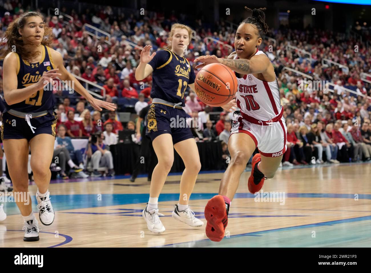 NC State's Aziaha James (10) chases a lose ball as Notre Dame's Anna ...