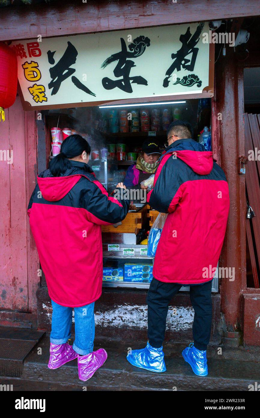 Chinese couple buying drinks at local take away snack hi-res stock ...